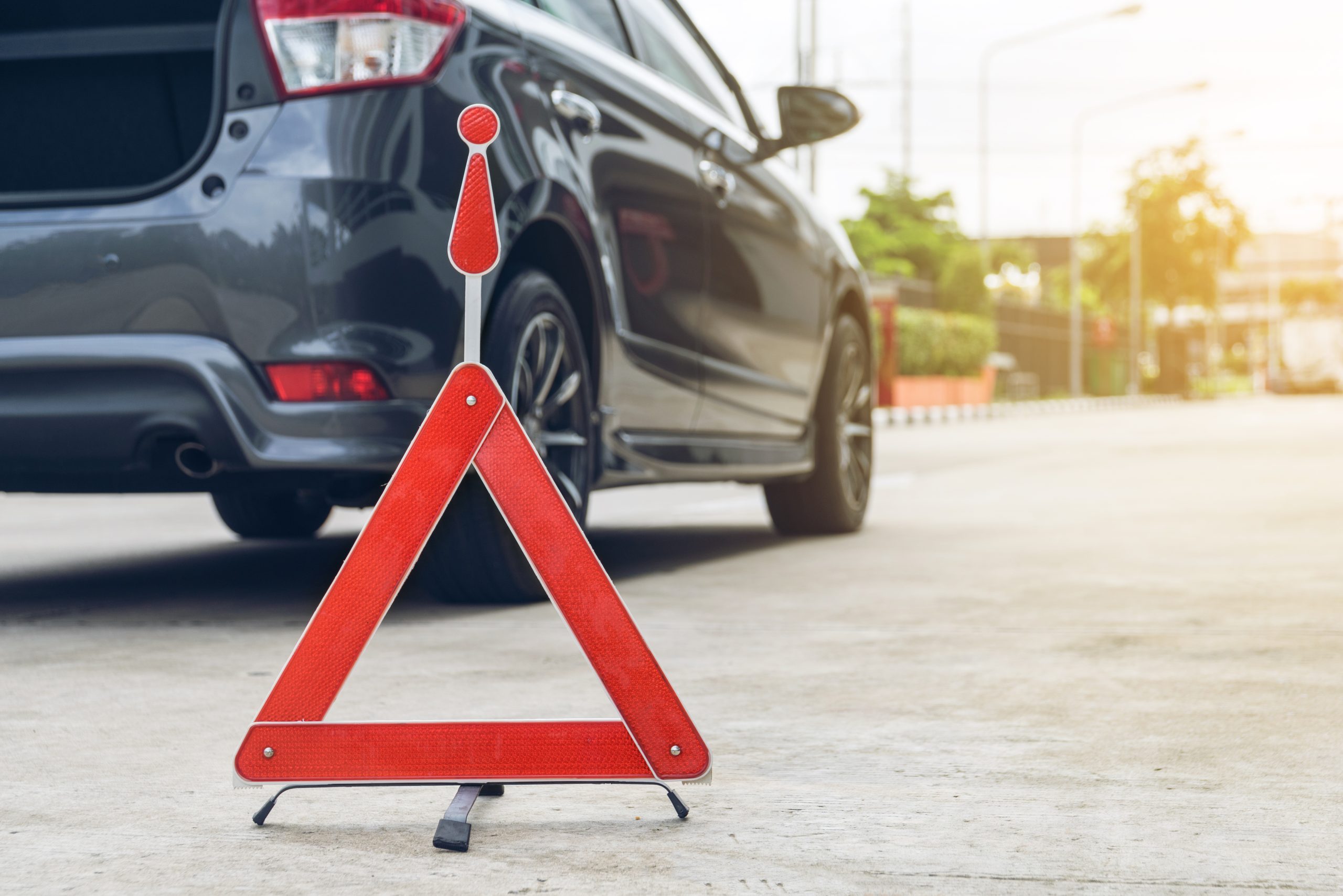 Broken car sign on a road with a broken down car - Safe Honest and ...